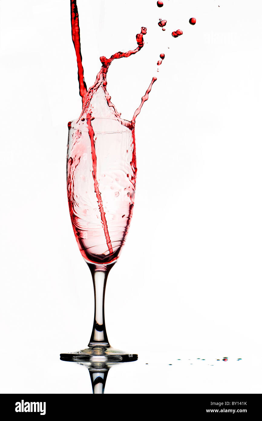 Pouring red wine. Wine splash isolated on white Stock Photo - Alamy