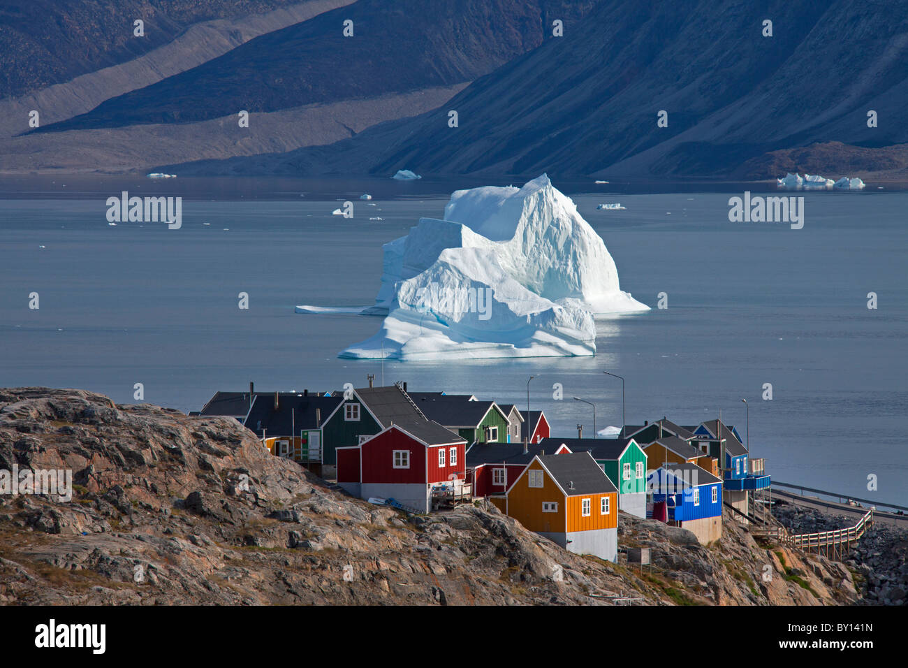 Uummannaq village with colourful houses and icebergs in the fjord ...