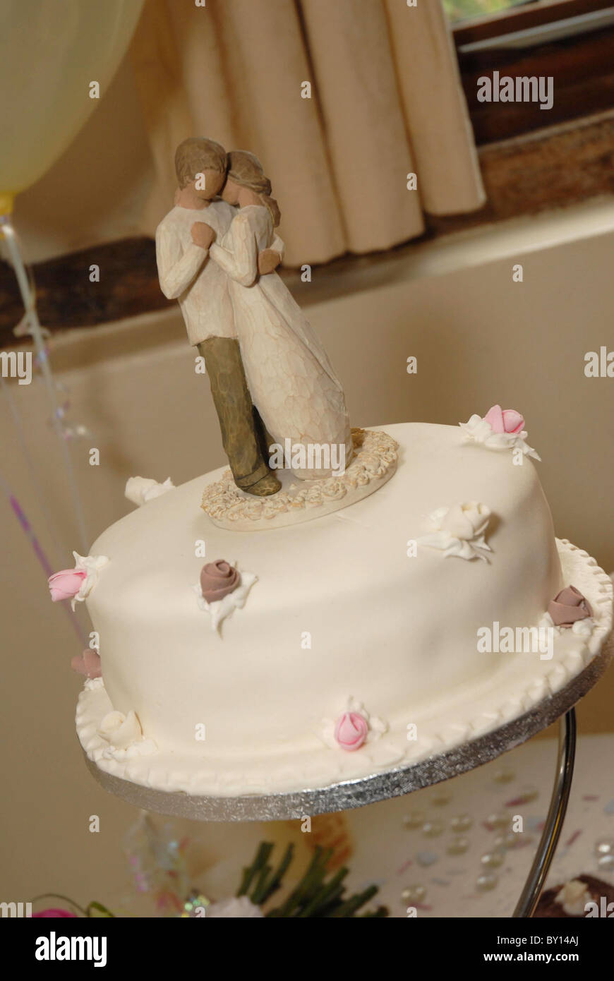 A close up of a wedding cake topper at reception Stock Photo - Alamy