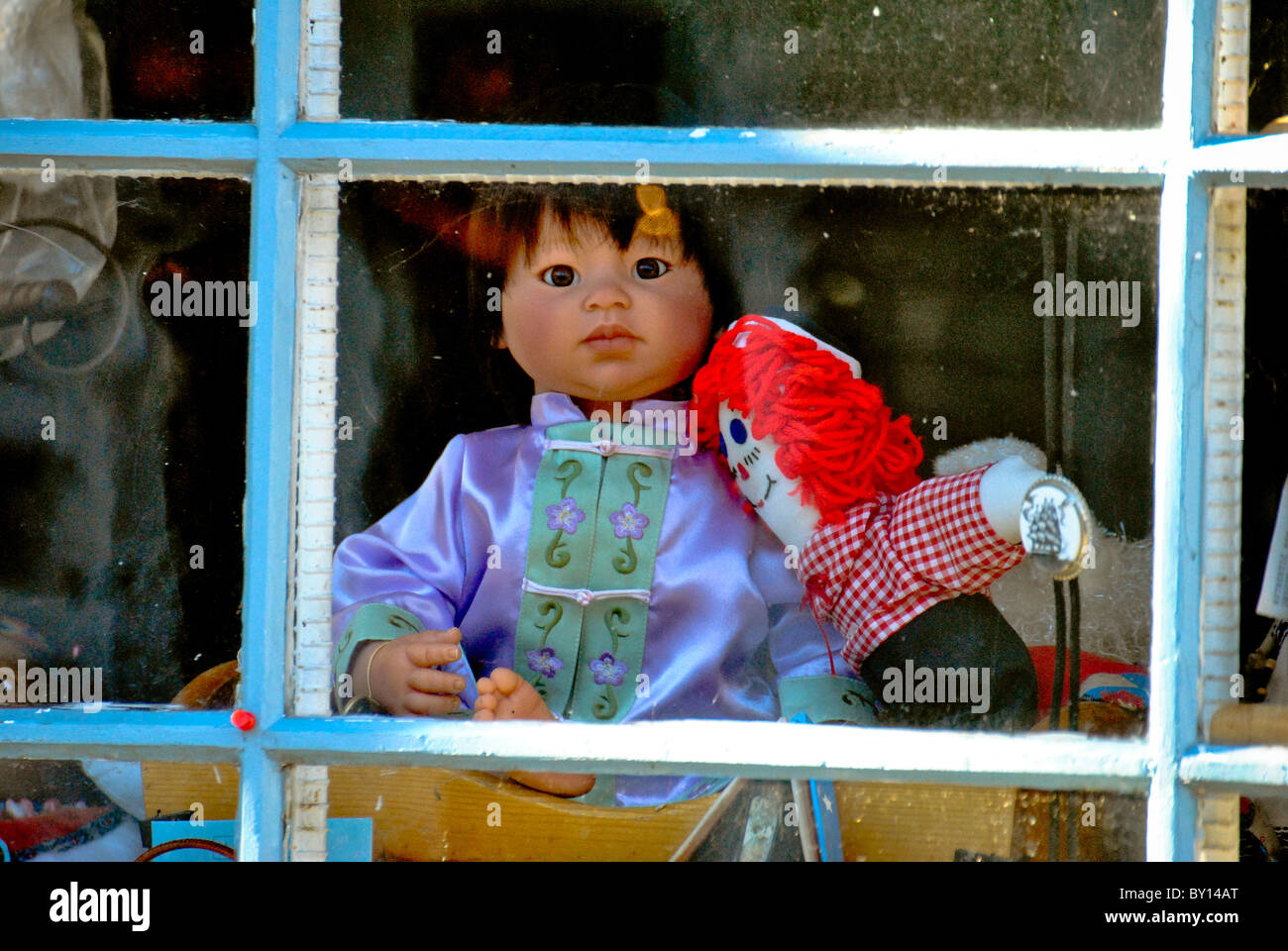 Two dolls in the window Stock Photo - Alamy