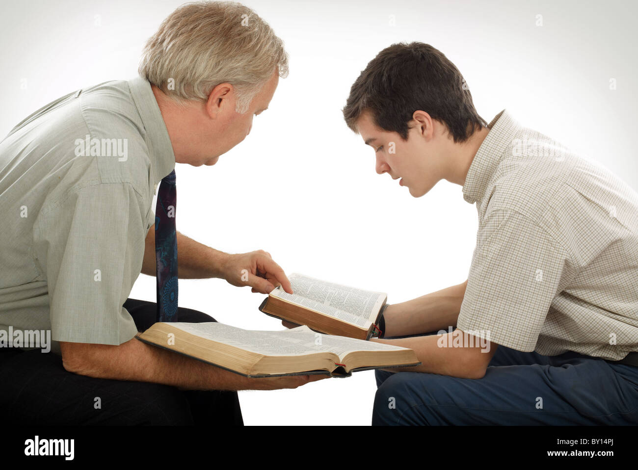 Preacher explains God's Word to a young man Stock Photo - Alamy