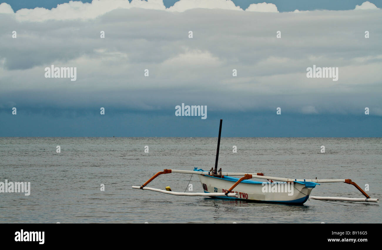 Fishing boat with dramatic storm front approaching Stock Photo - Alamy