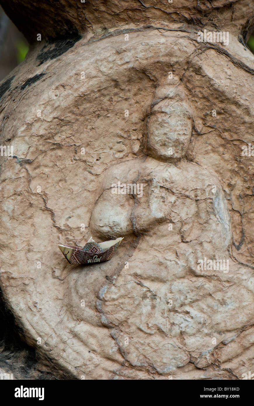 old bas-relief of Buddha in a circular frame with a money boat's ...