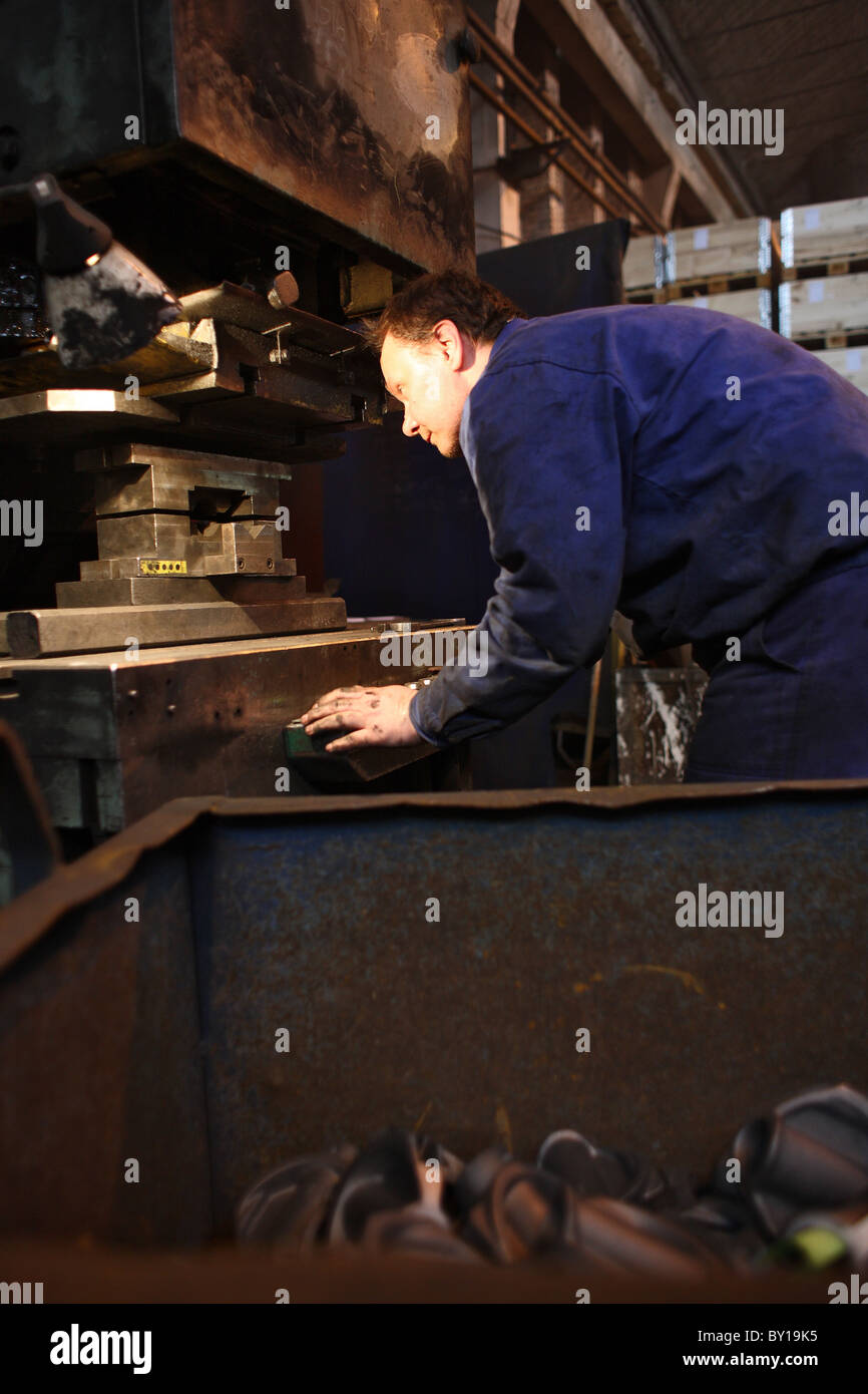 A worker at a metal press, Poznan, Poland Stock Photo - Alamy