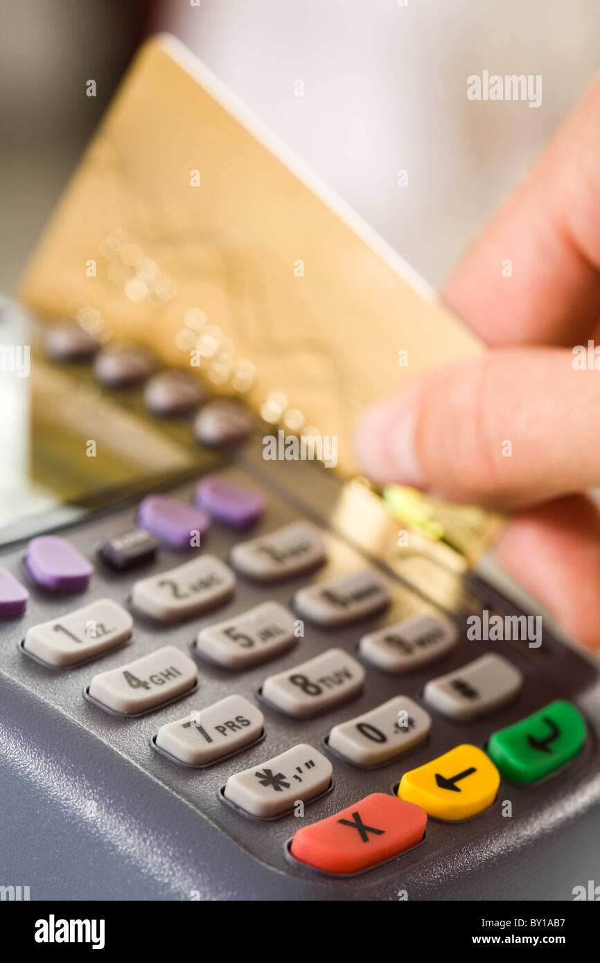 Close-up of payment machine buttons with human hand holding plastic ...