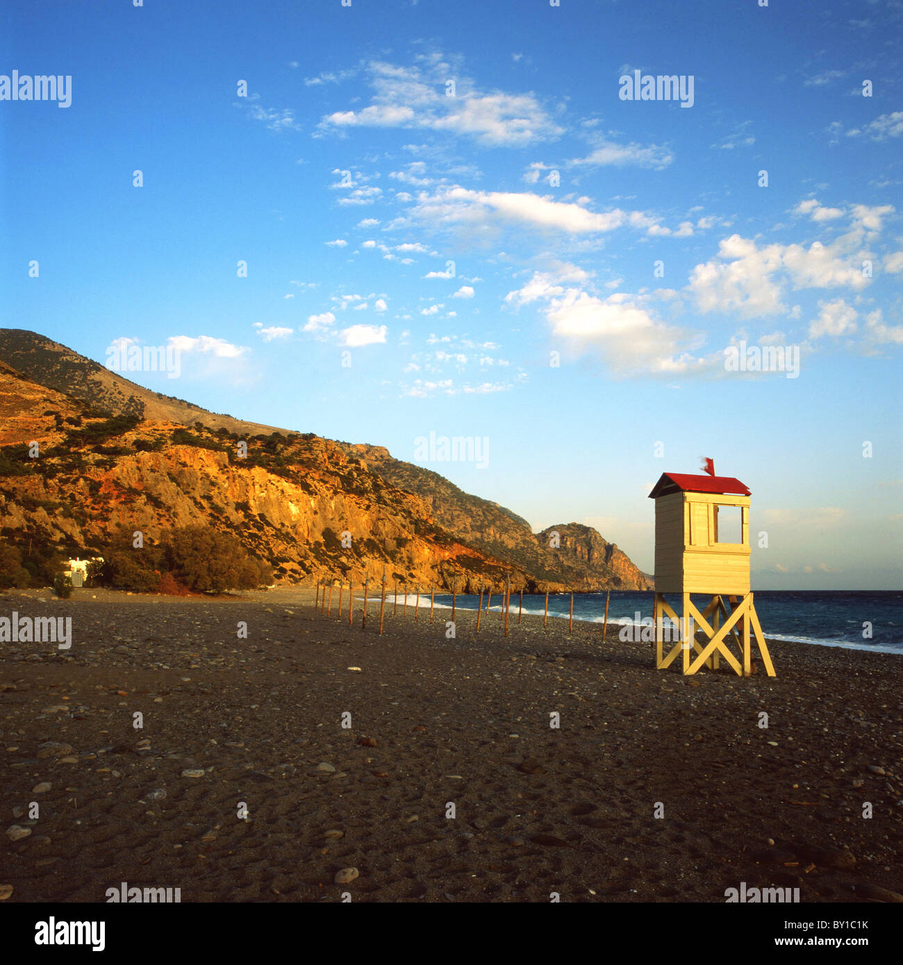 A tattered red flag, am empty lifeguard box and a phalanx of umbrella ...