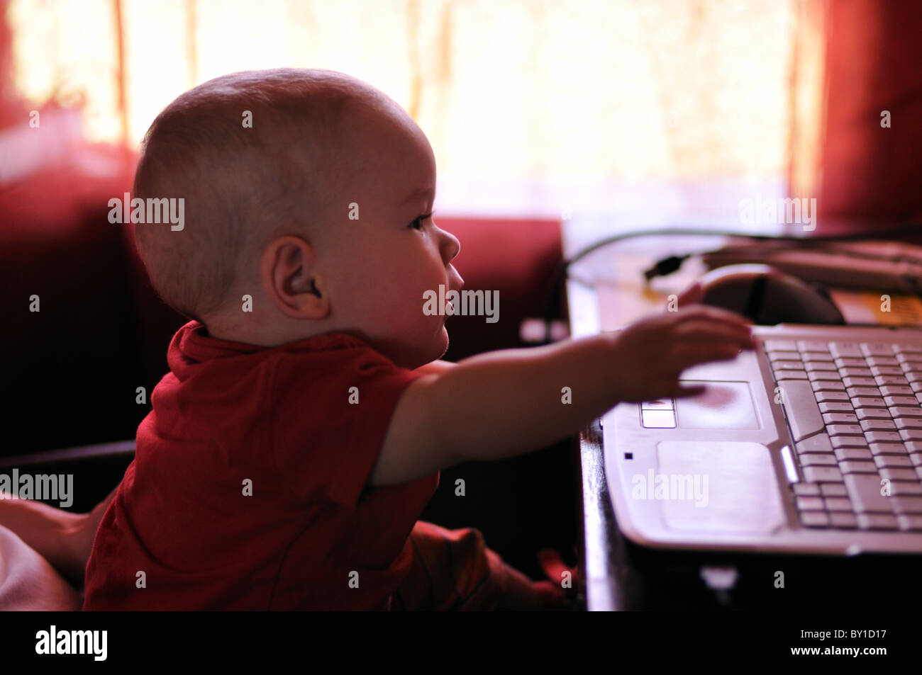 Toddler playing with a laptop keyboard Stock Photo - Alamy