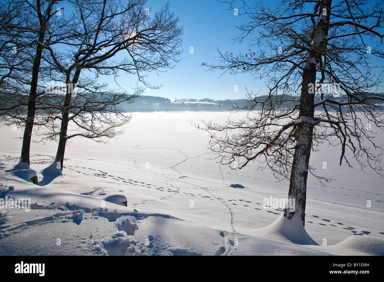 Frozen lake covered in ice and snow Stock Photo - Alamy