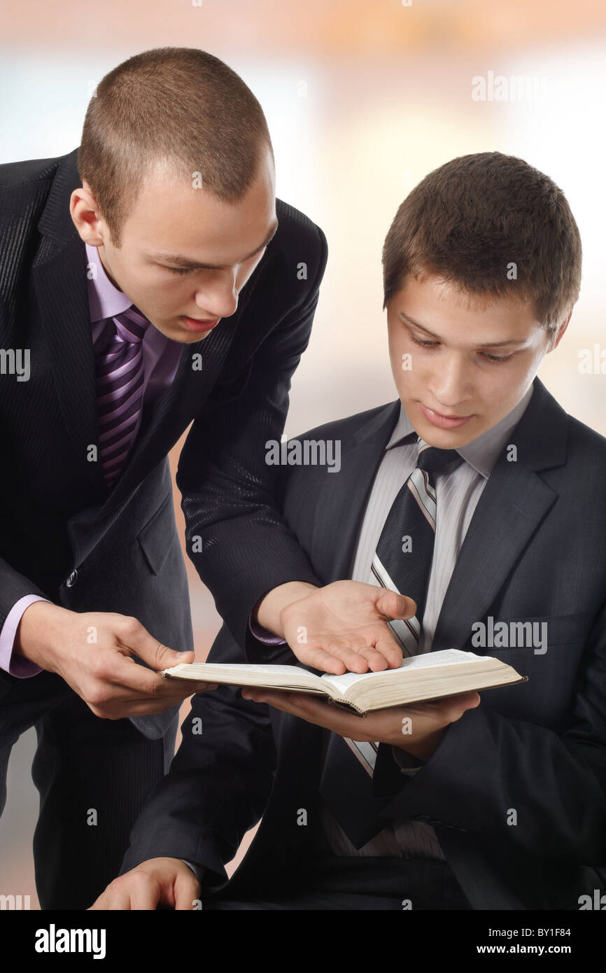 Young man showing a truth in the Bible, to another young man Stock ...