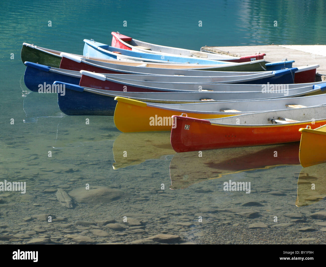 COLOURFUL CANOES AT MORAINE LAKE, CANADIAN ROCKIES, CANADA Stock Photo ...