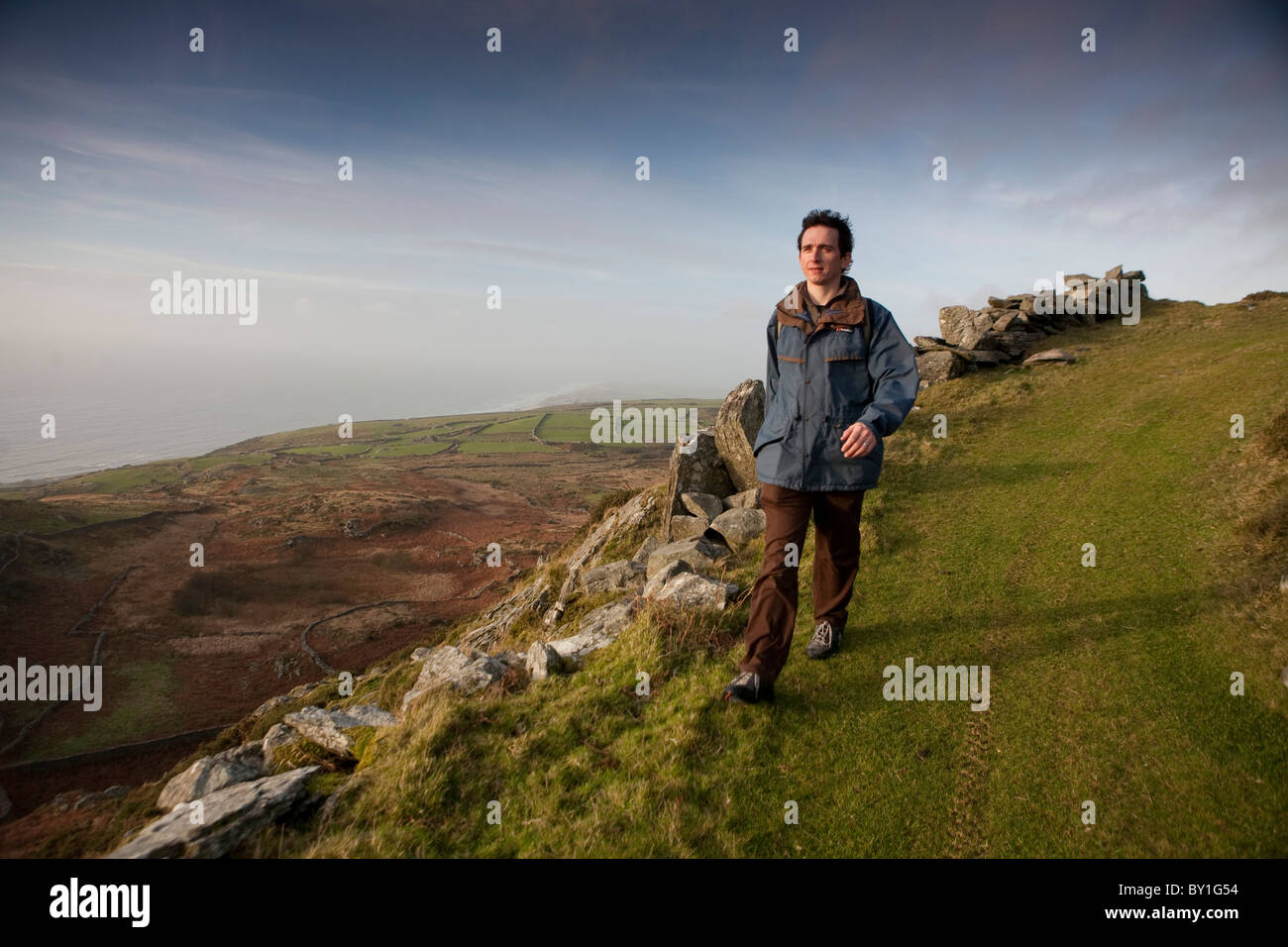 Walker on path on country walk in Wales Stock Photo - Alamy