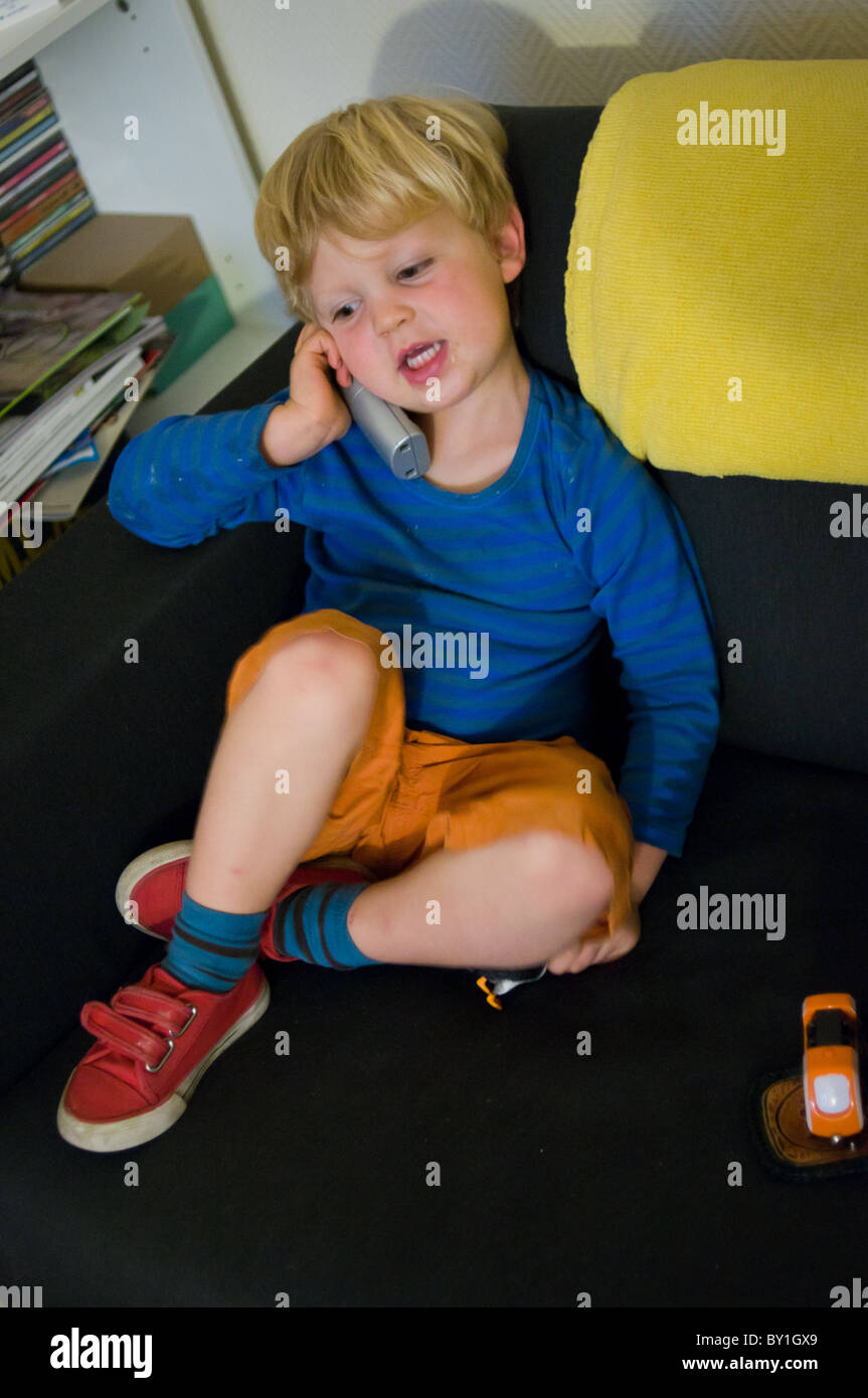 Young boy talking on the telephone Stock Photo - Alamy