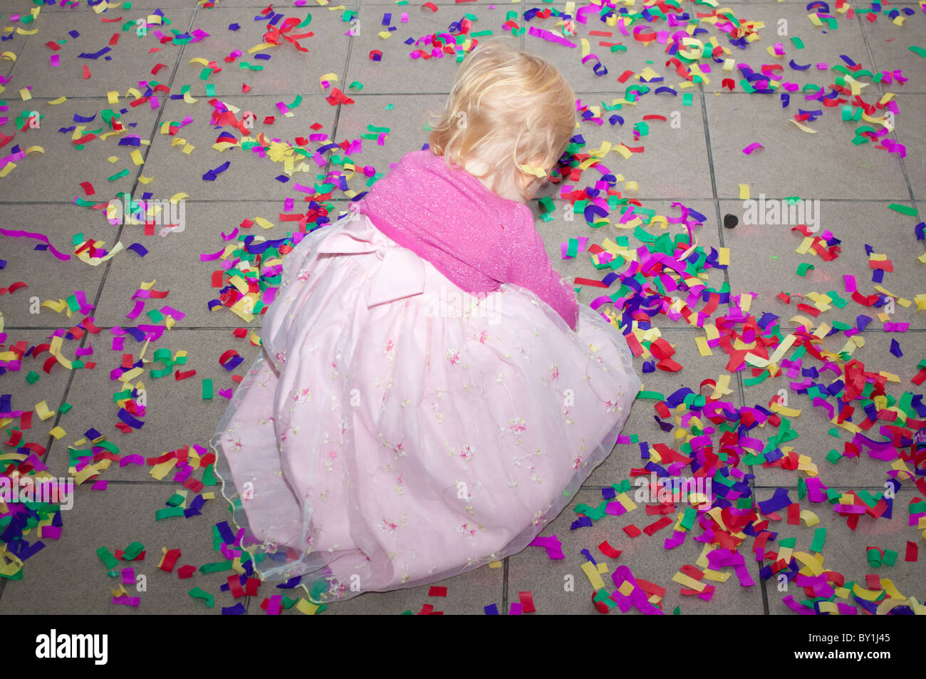 little girl playing with confetti Stock Photo - Alamy