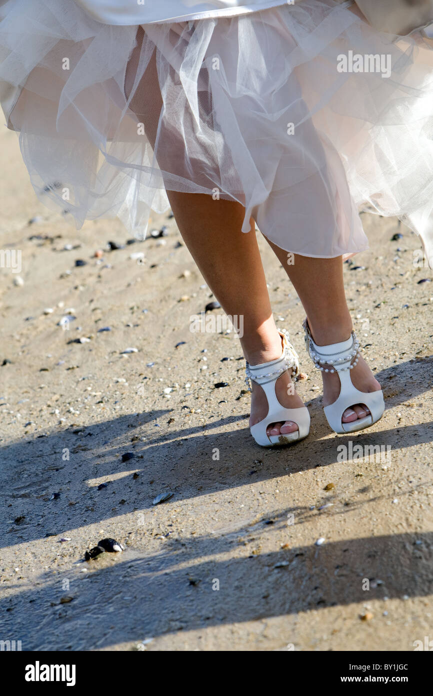 Bride walking on sand hi-res stock photography and images - Alamy