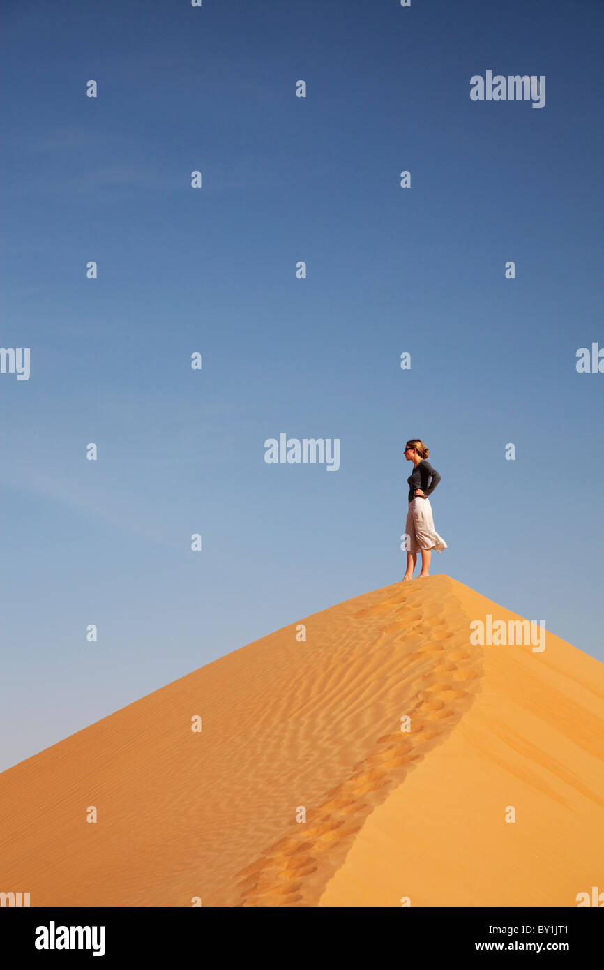 Oman, Empty Quarter. Oman, Empty Quarter. A young lady standing at the ...