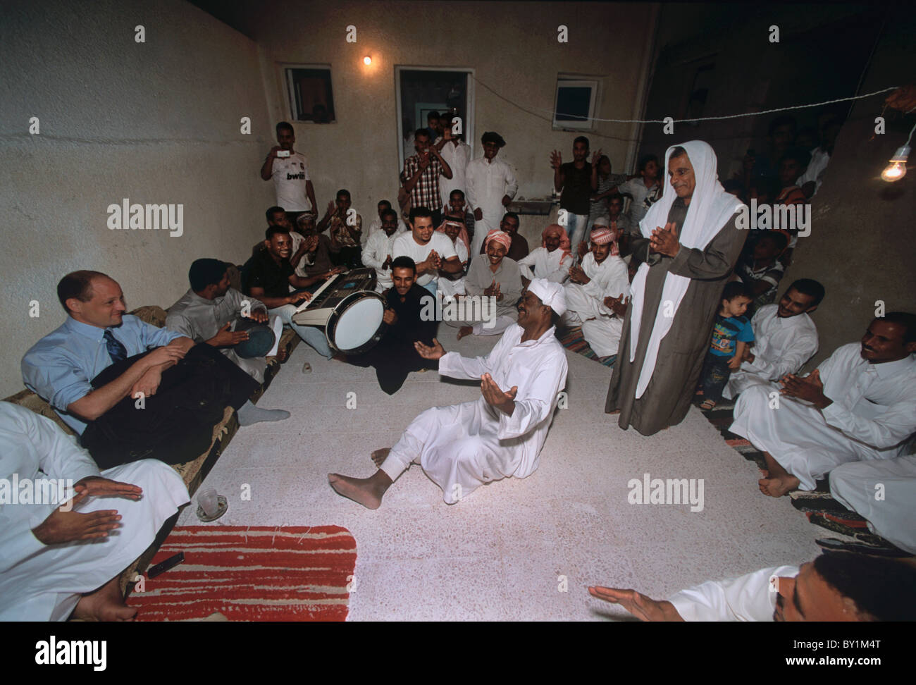 Tourist watches Bedouins dance at traditional wedding celebration. El ...