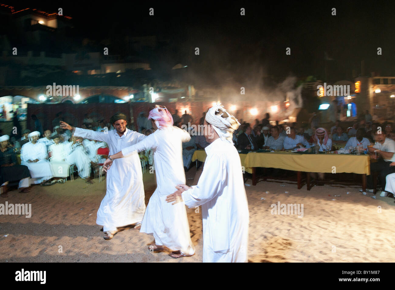 Men attending traditional Bedouin wedding celebration dance as guests ...