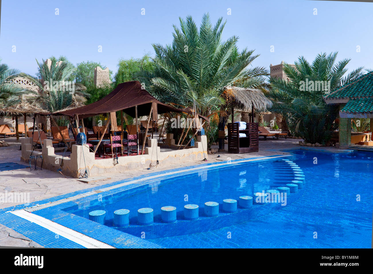 The swimming pool area of the Hotel Kasbah Xaluca in Erfoud, Morocco ...
