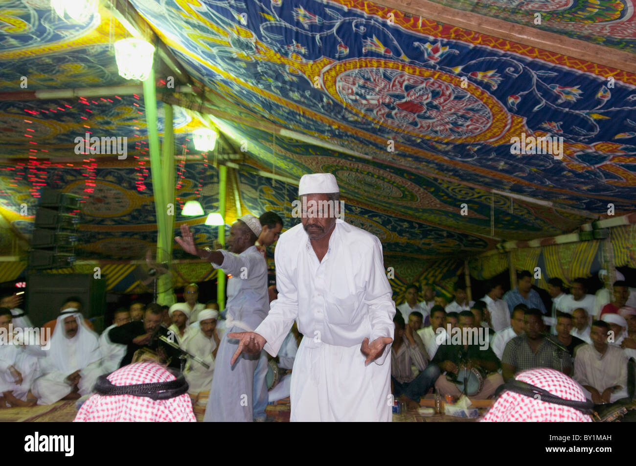 Guests celebrate with dance as other guests look on during a ...