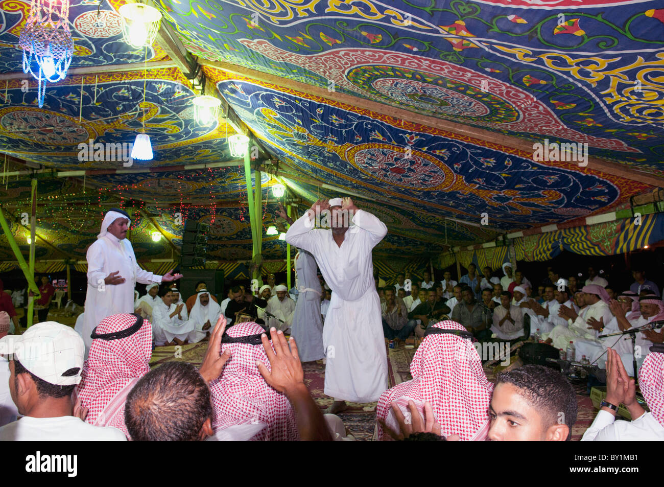 Guests celebrate with dance as other guests look on during a ...