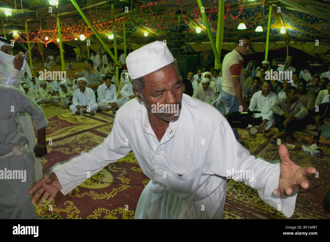 Guests celebrate with dance as other guests look on during a ...