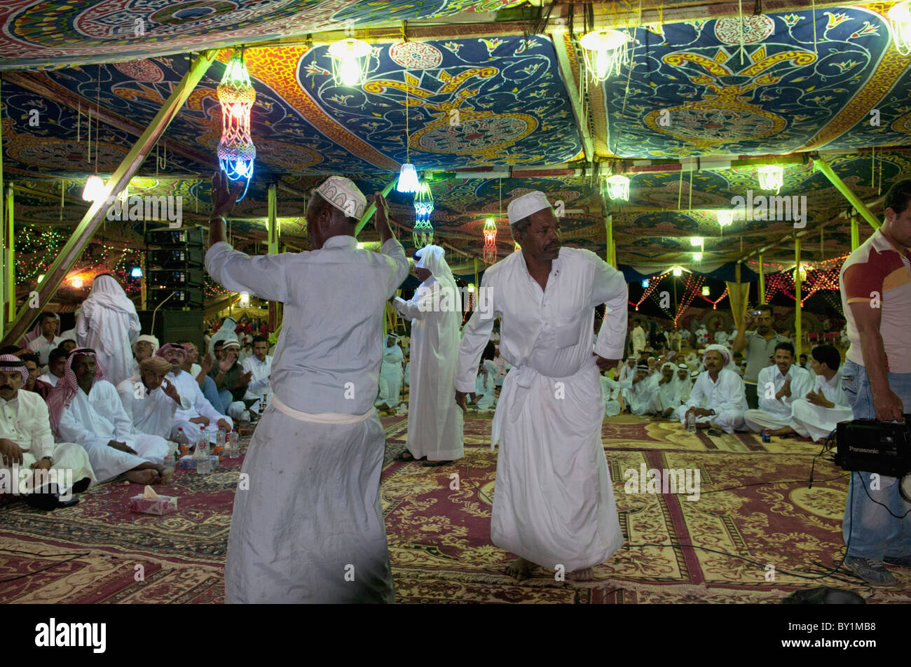 Guests celebrate with dance as other guests look on during a ...