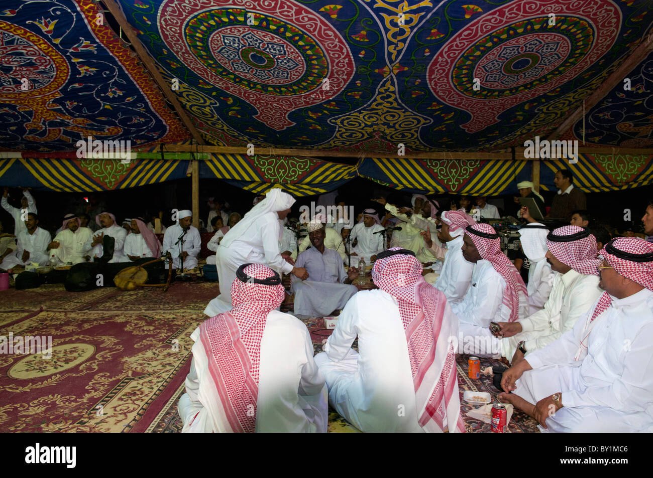 Guests celebrate with dance as other guests look on during a ...