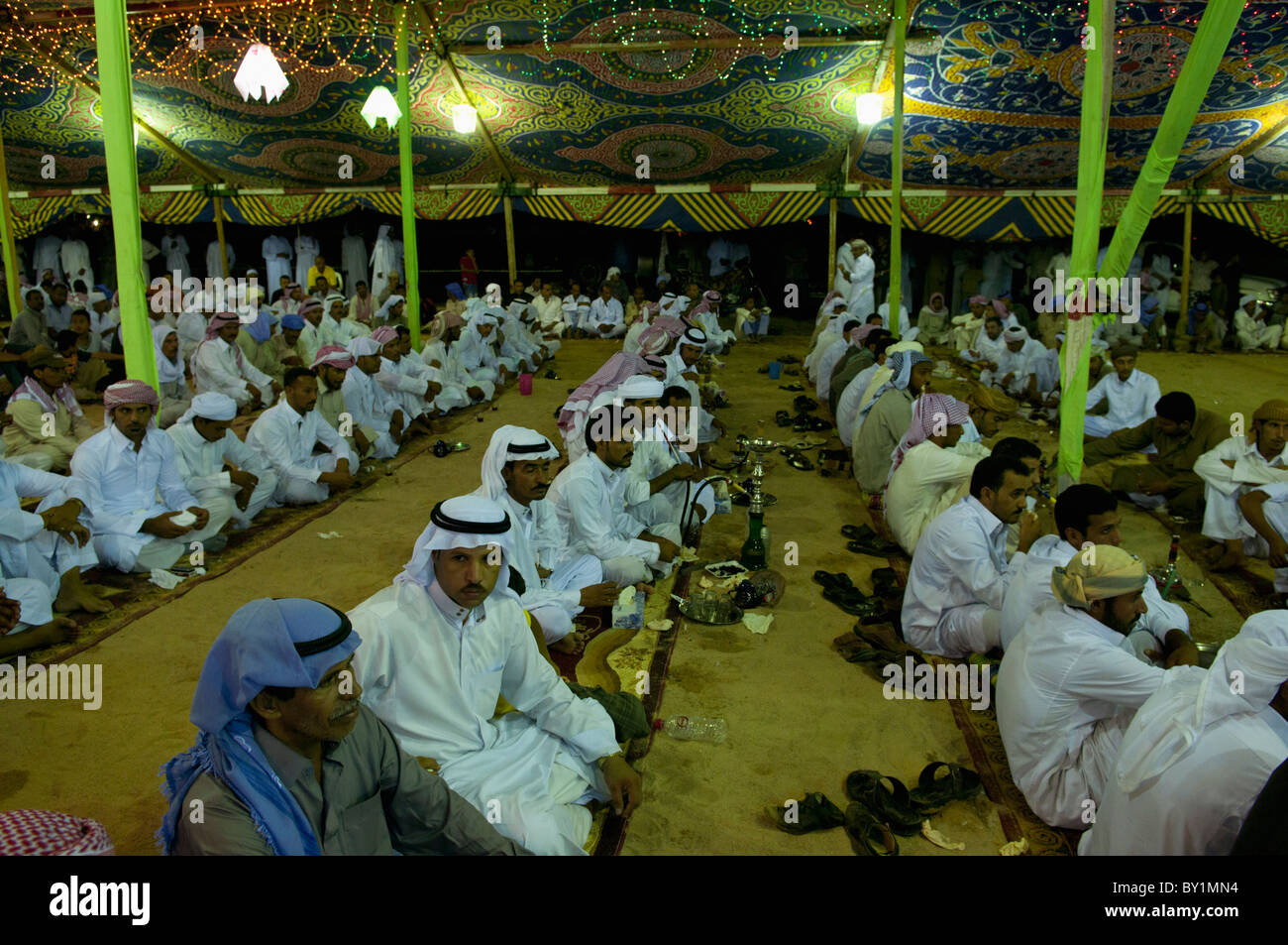Seated guests await entertainment during a traditional Bedouin wedding ...