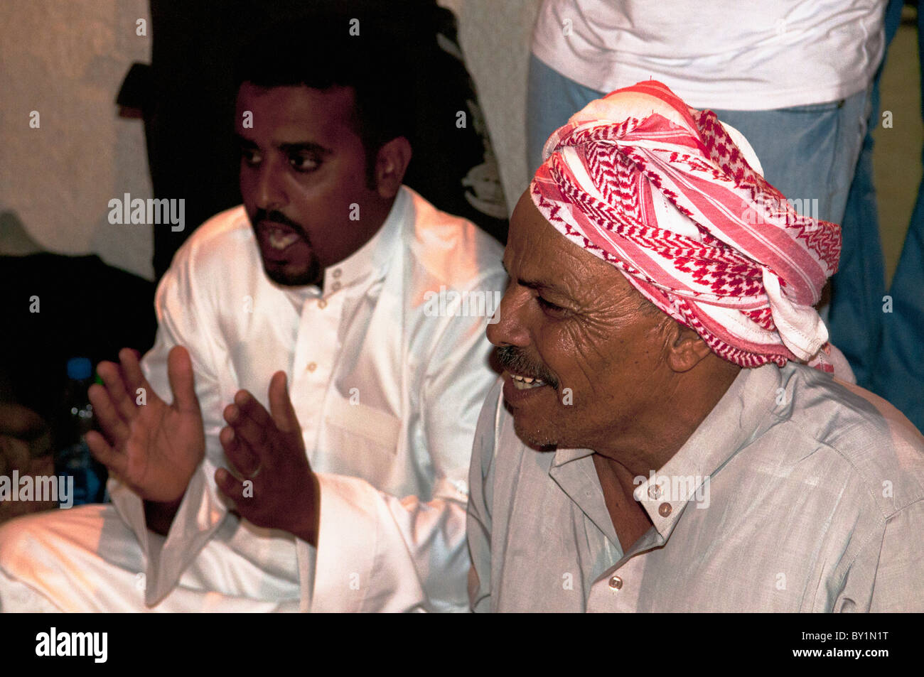 Bedouin guests sing at traditional wedding celebration. El Tur, Sinai ...