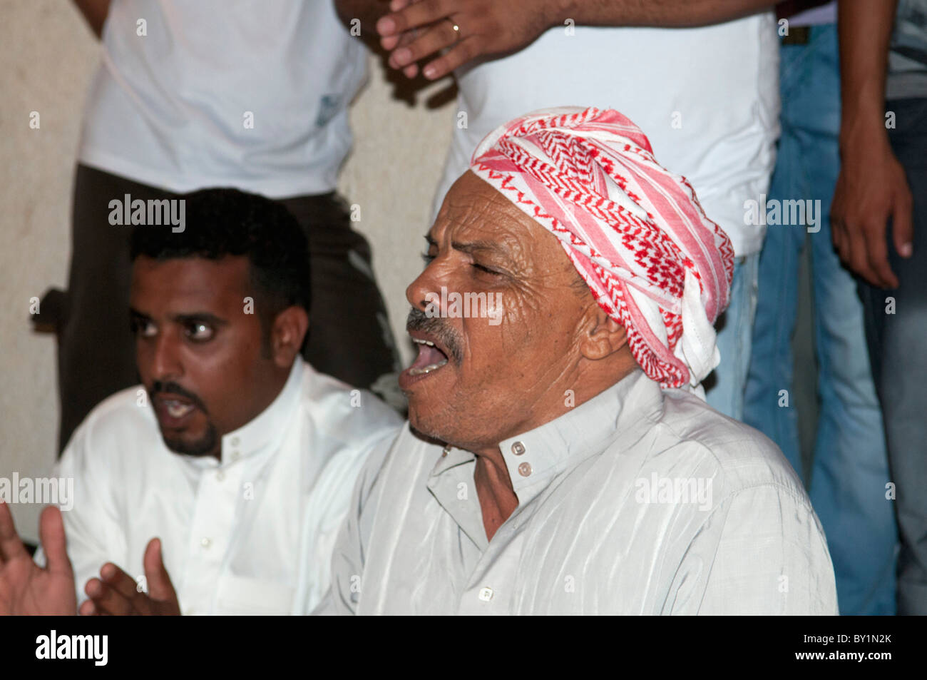 Bedouin guests sing at traditional wedding celebration. El Tur, Sinai ...