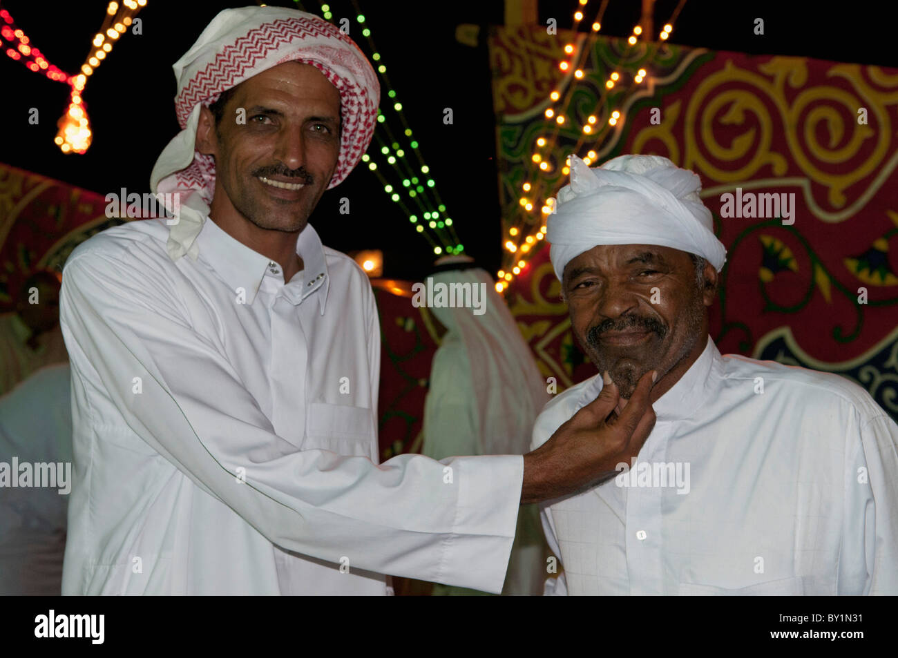 Father and son celebrate at a traditional Bedouin wedding. El Tur ...