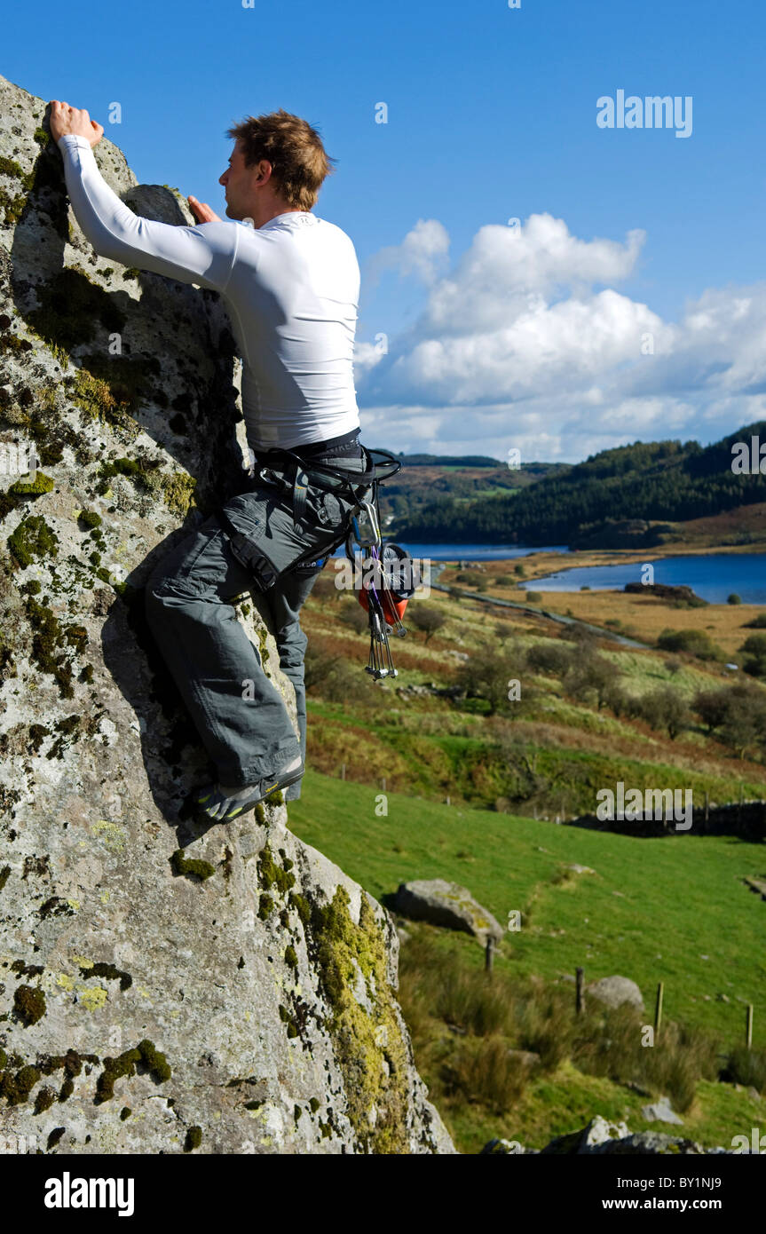 UK, North Wales, Snowdonia. A man rock climbing on a large granite ...