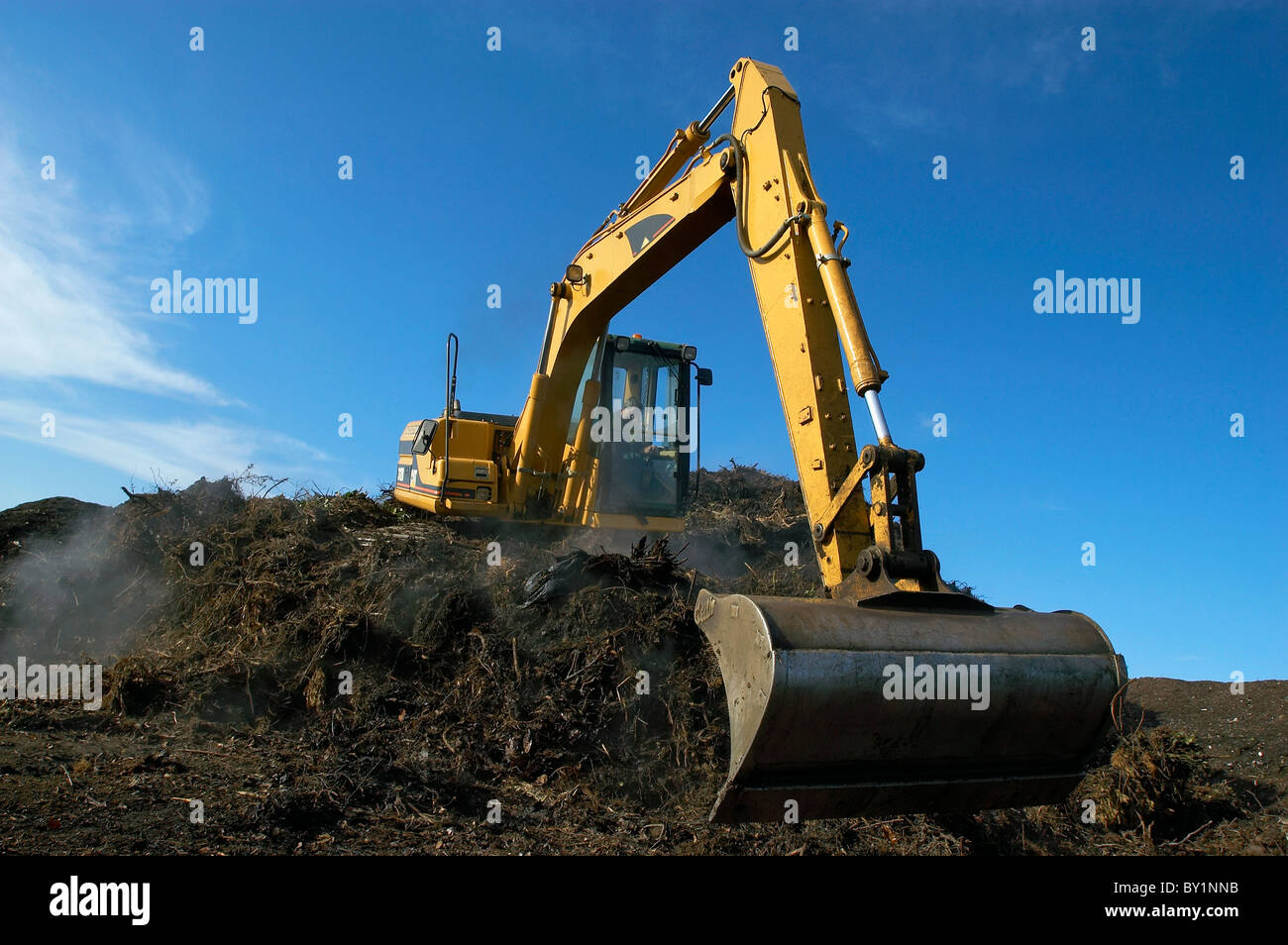 Tracked excavator on landfill Stock Photo - Alamy