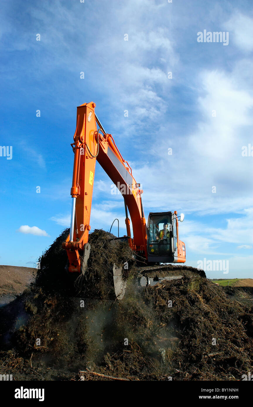 Tracked excavator on landfill Stock Photo - Alamy