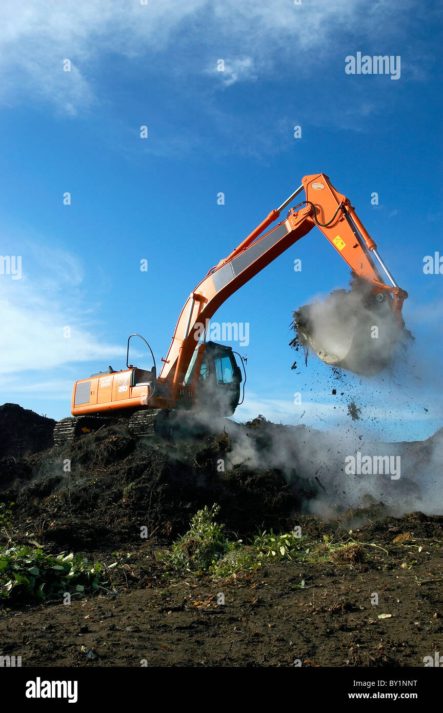 Tracked excavator on landfill Stock Photo - Alamy