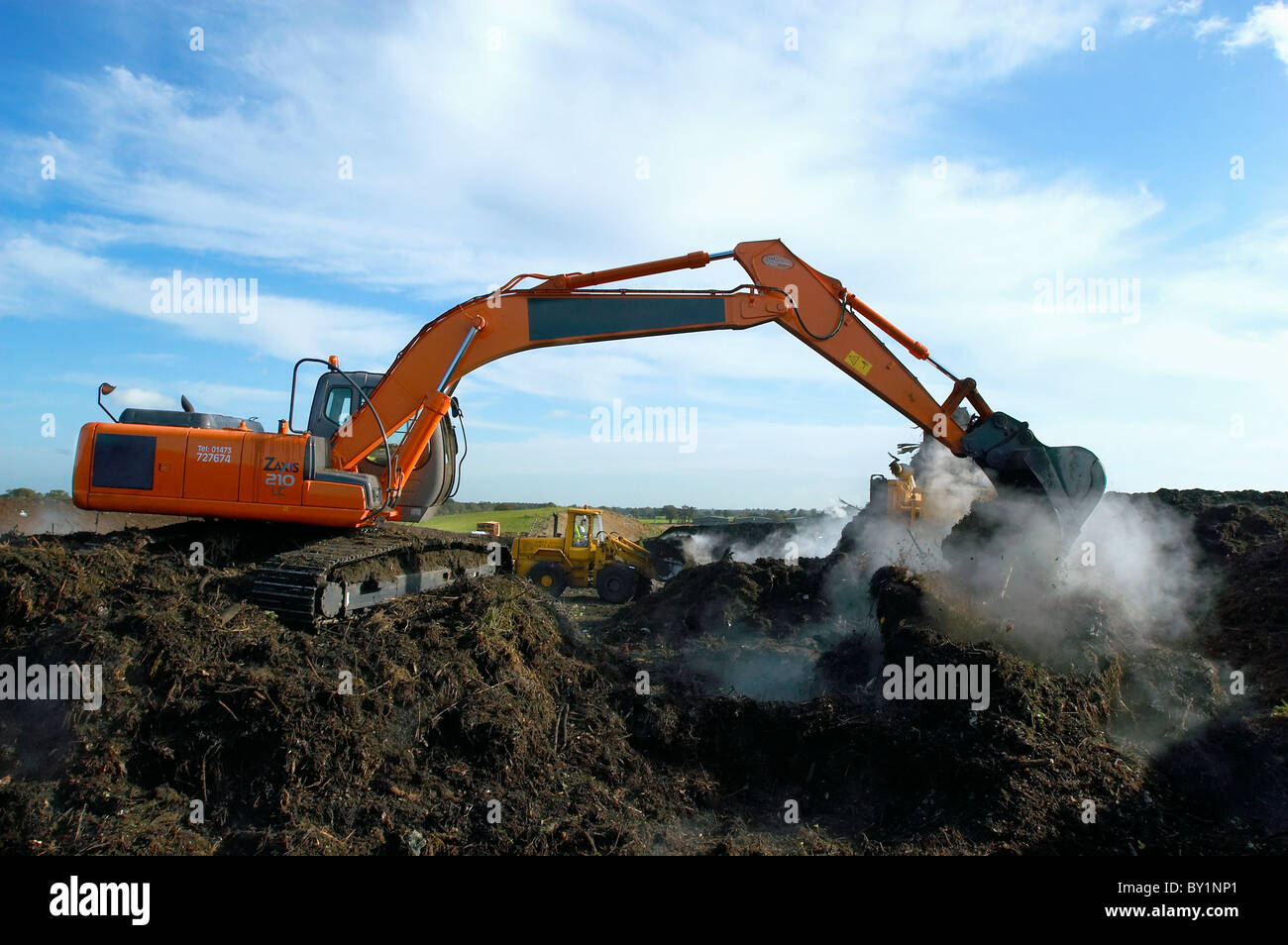 Tracked excavator on landfill Stock Photo - Alamy
