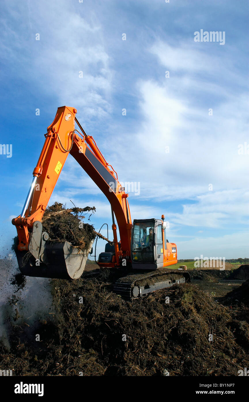 Tracked excavator on landfill Stock Photo - Alamy