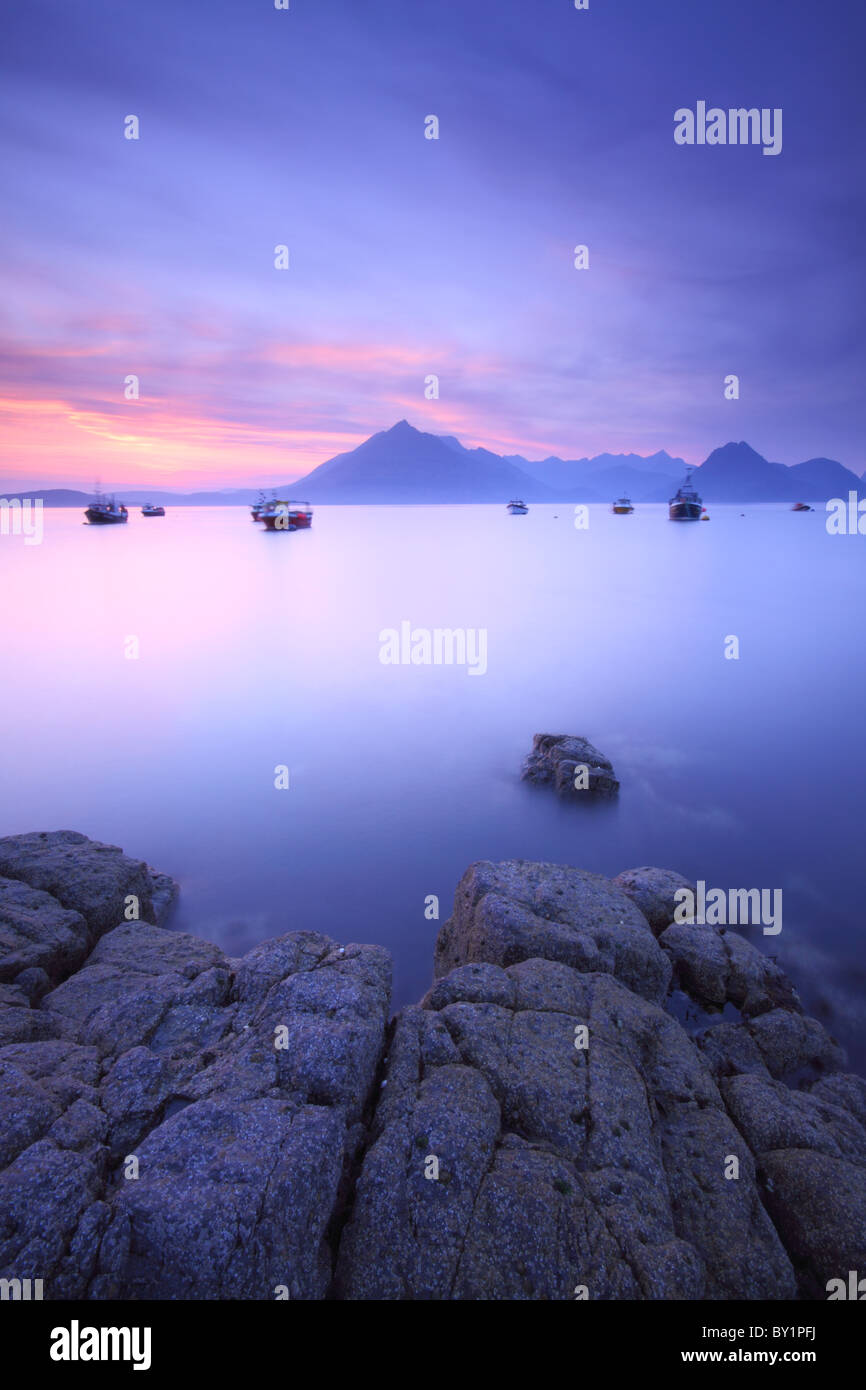 Boats sit at anchor in Elgol Harbour, Isle of Skye as the dying sun ...