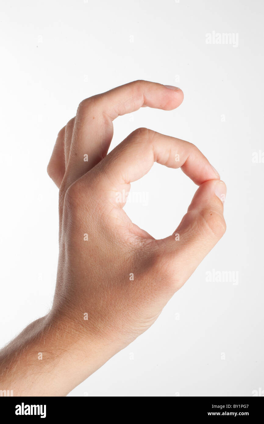 Hand making the 'OK' sign against a white background. Background can be ...