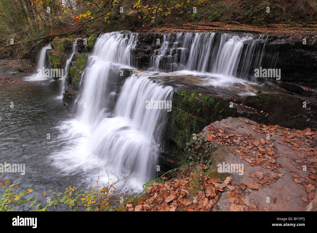 A Waterfall cascades over a rock ledge, Ystradfellte, Brecon Beacons ...