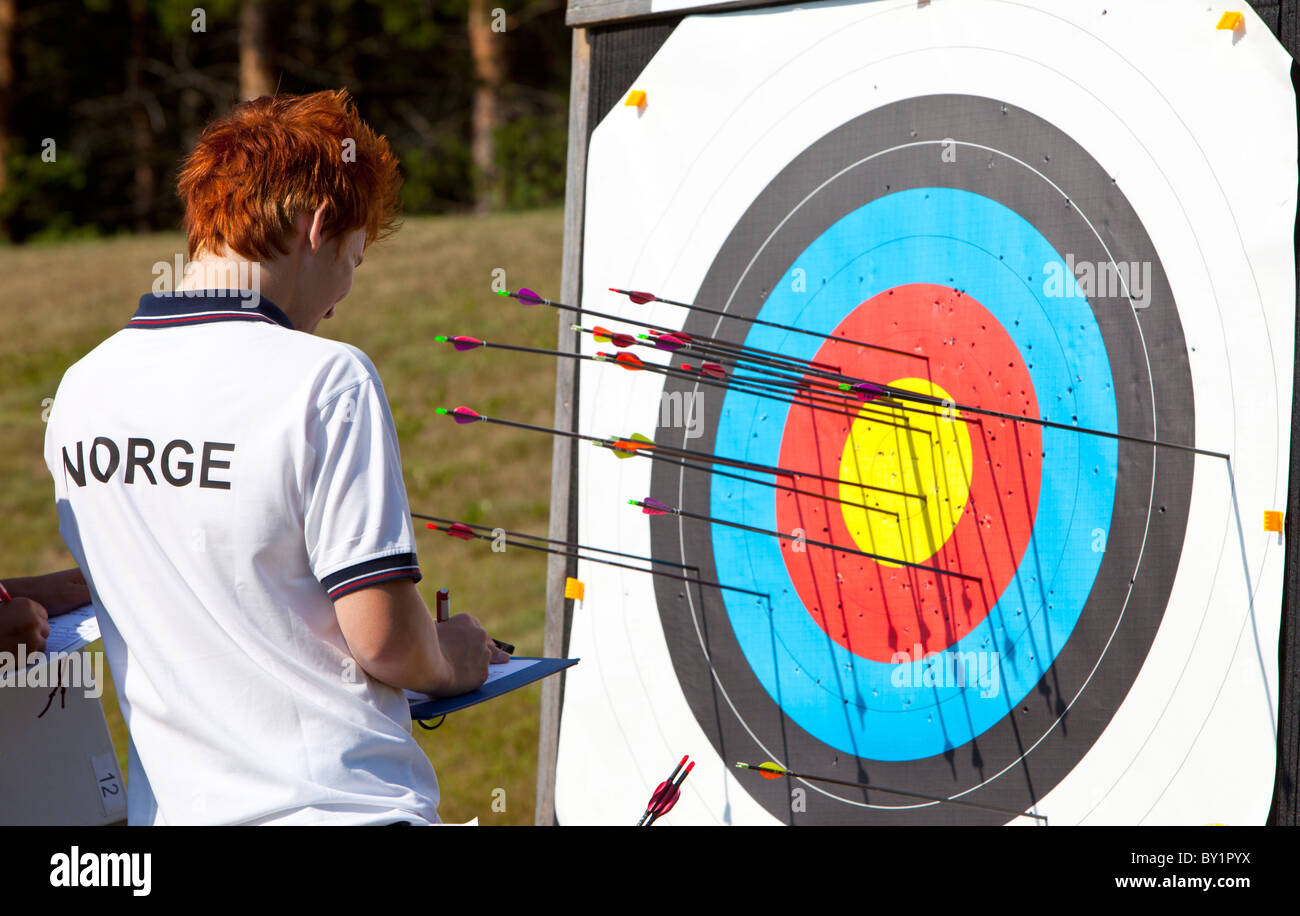 Young archer calculating points in an international competition between ...
