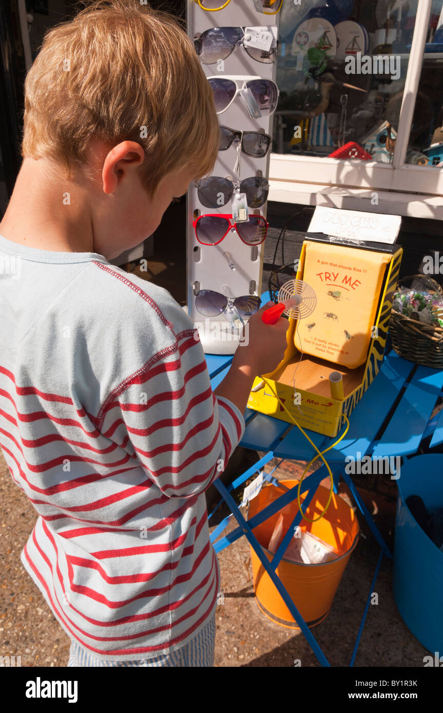 A MODEL RELEASED boy trying a toy fly swatting gun out in the Uk Stock ...