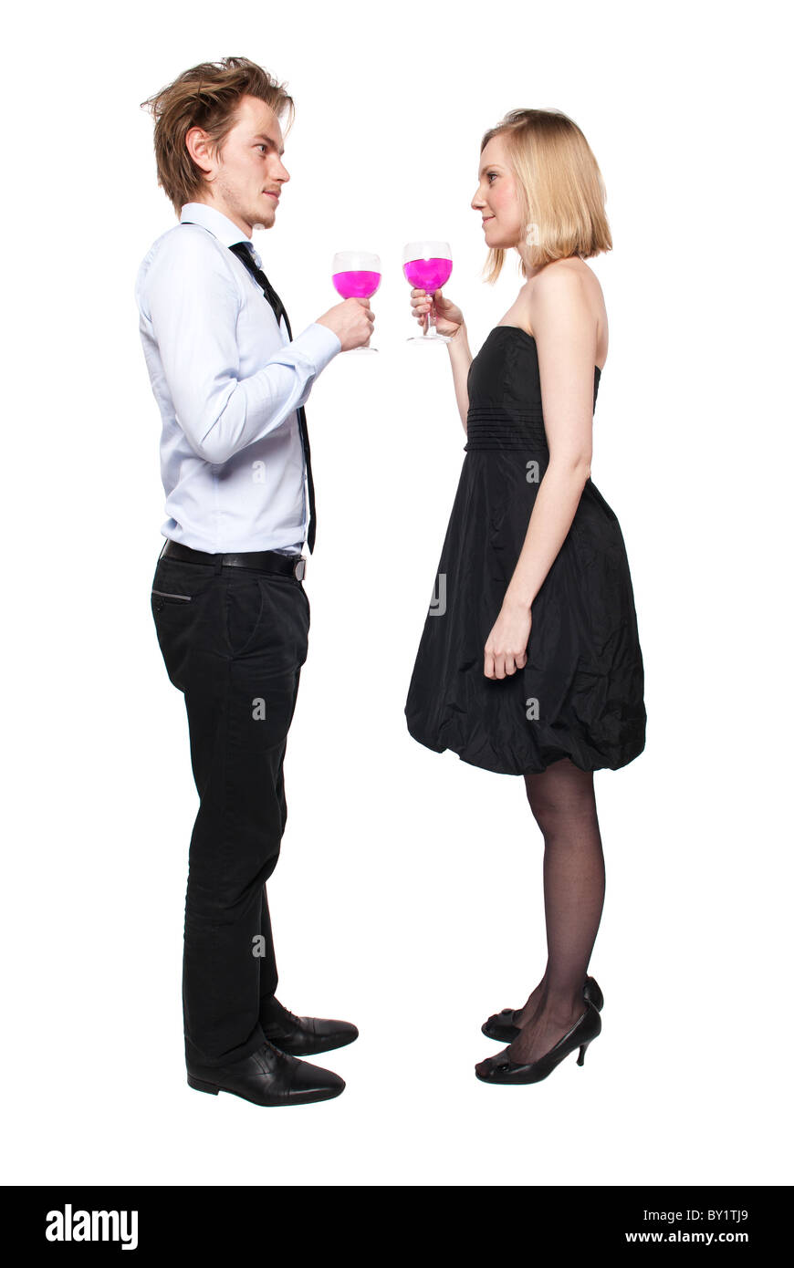 Young couple toasting with pink drink. Two people drinking. Studio ...