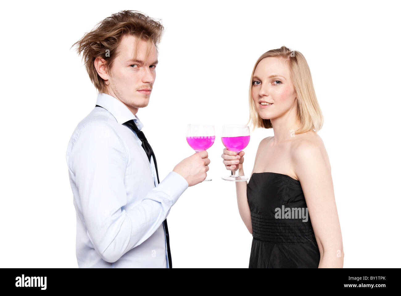 Young couple toasting with pink drink. Two people drinking. Studio ...