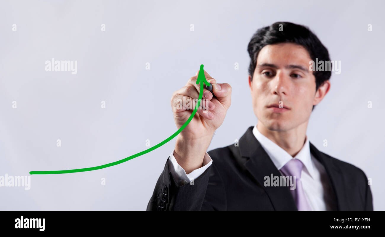 Modern businessman writing the business stats progress in the ...
