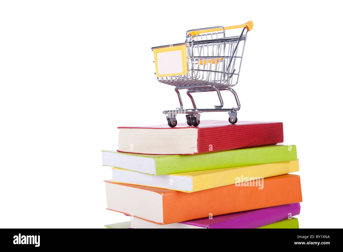 Stack of color books and a shopping cart (isolated on white Stock Photo ...
