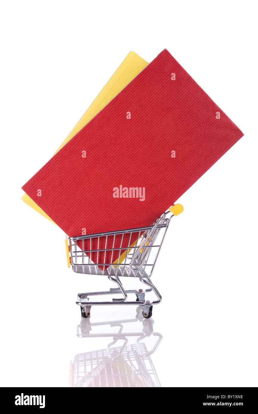 Stack of color books and a shopping cart (isolated on white Stock Photo ...