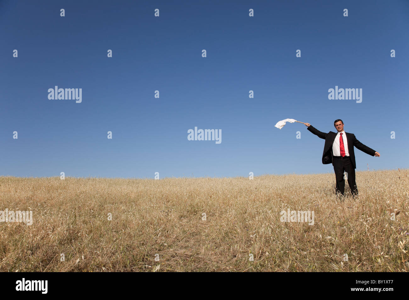 businessman asking for surrendering with a white flag Stock Photo - Alamy