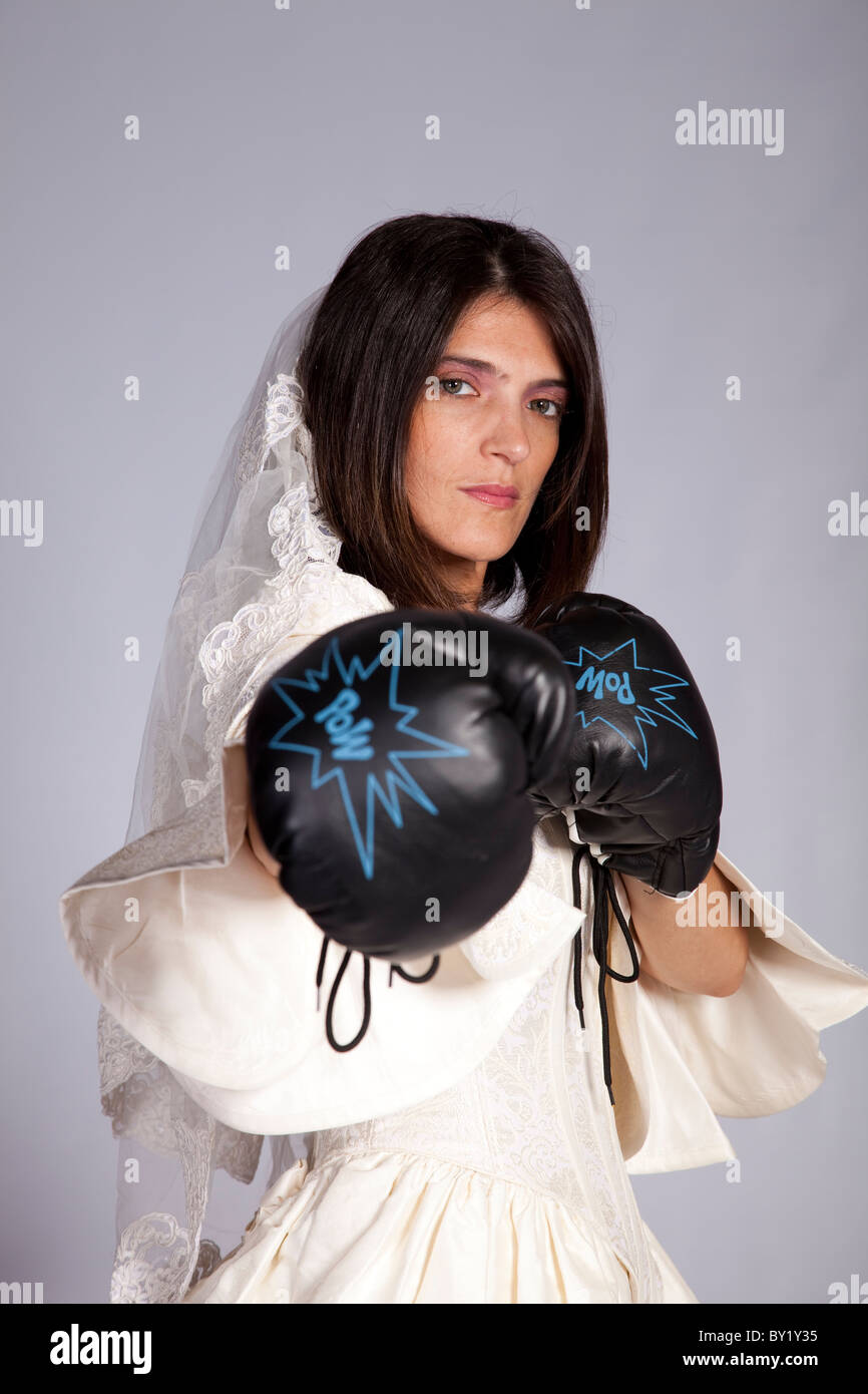 Crazy beautiful bride with boxing gloves (grey background Stock Photo ...