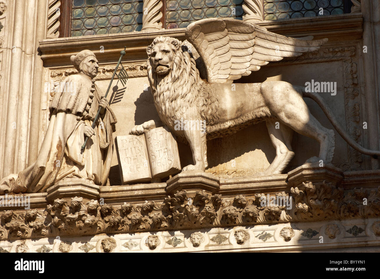 Statue of the Doge & The Winged Lion of St Mark above a doorway to the ...